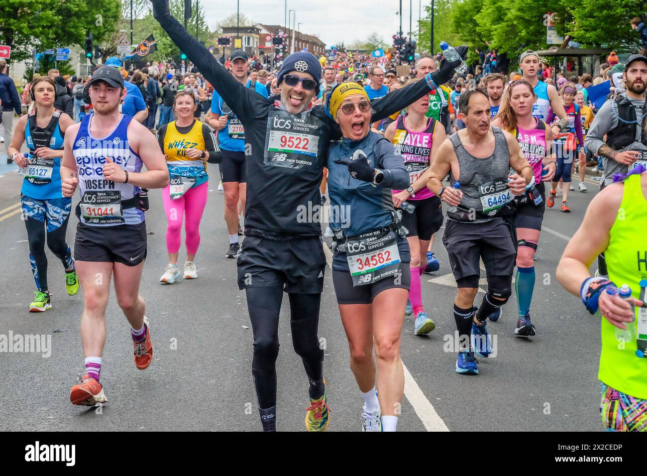 Couple pose for photographs on route of London Marathon 2024 Stock ...