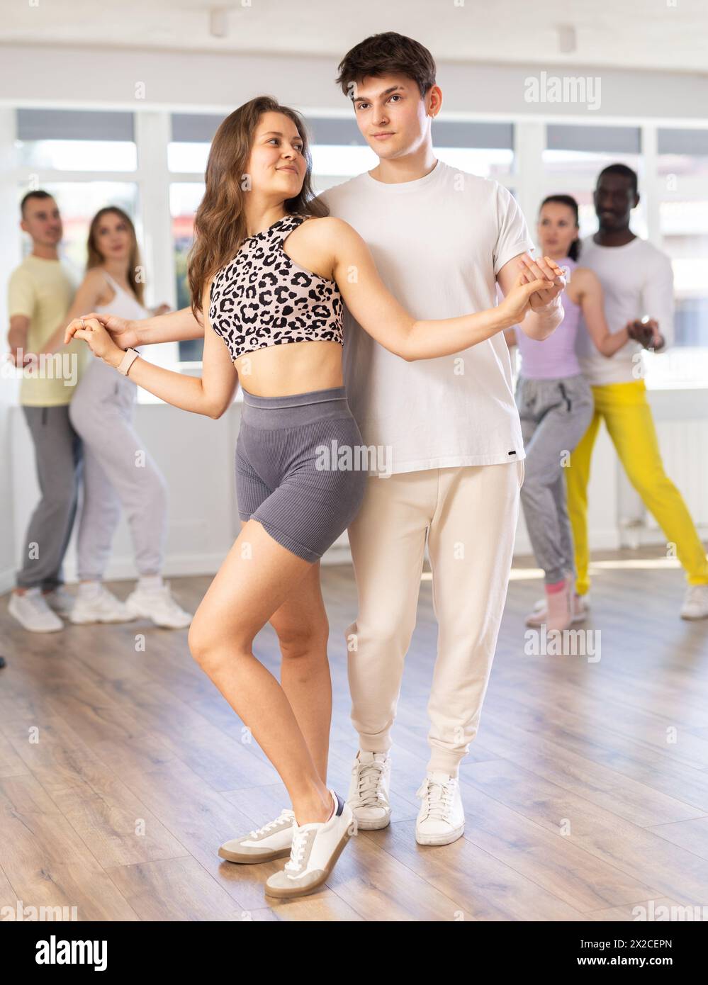 Men and women of different nationalities dancing salsa o bachata in ...
