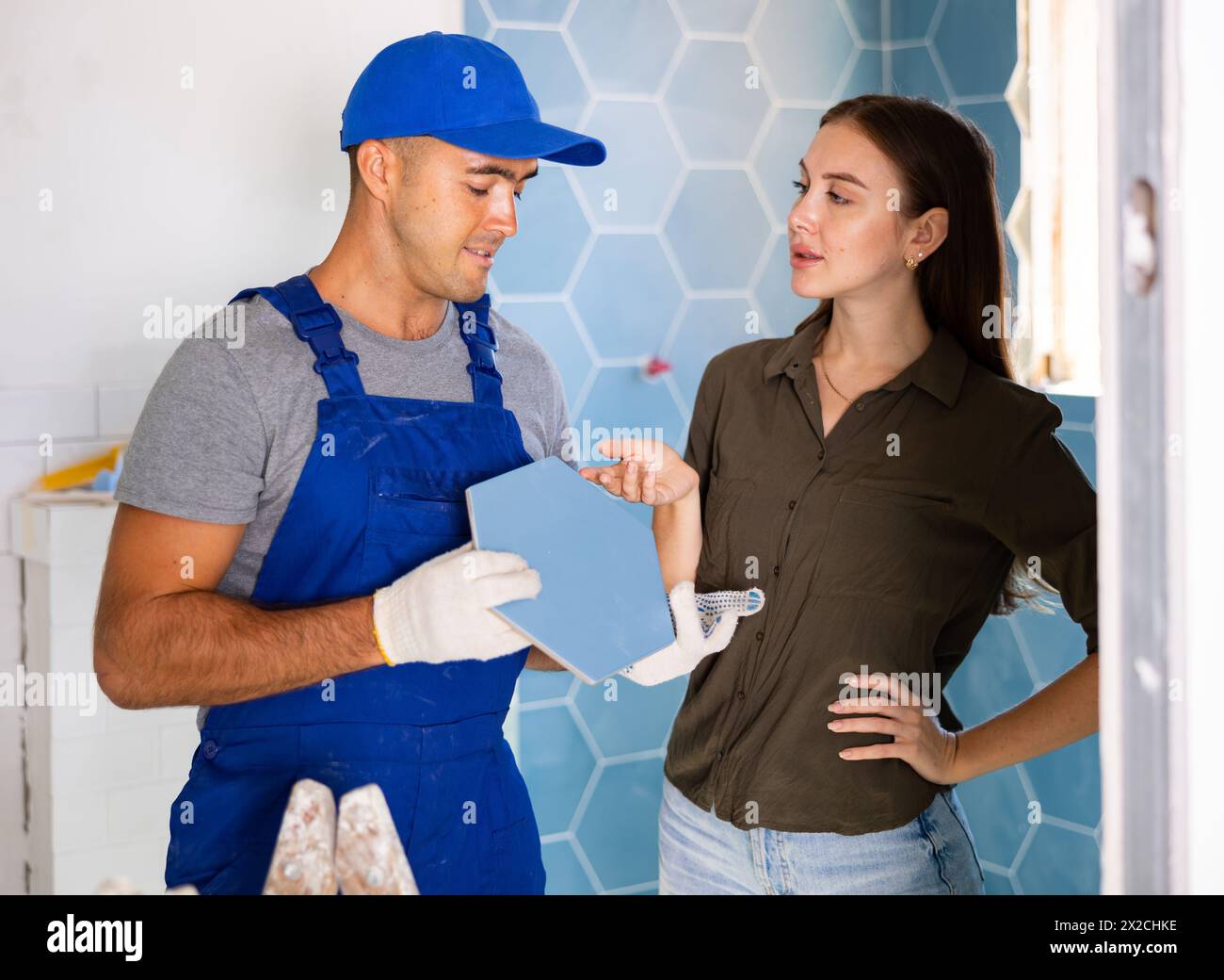 Female owner consults with a professional builder about installing a ...