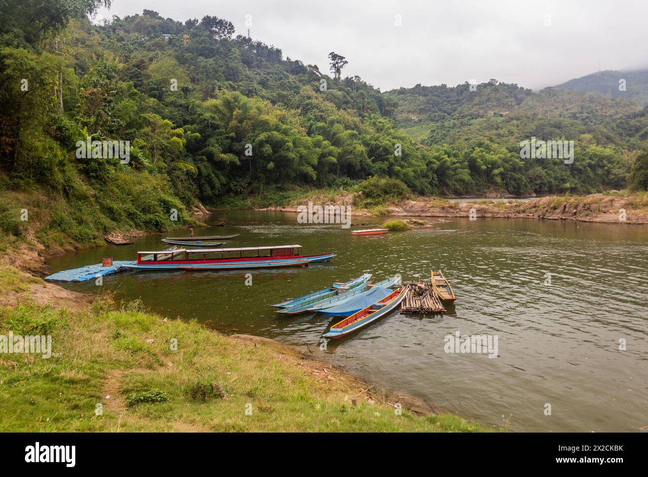 Boats on Nam Ou river in Hat Sa village in Phongsali province, Laos ...