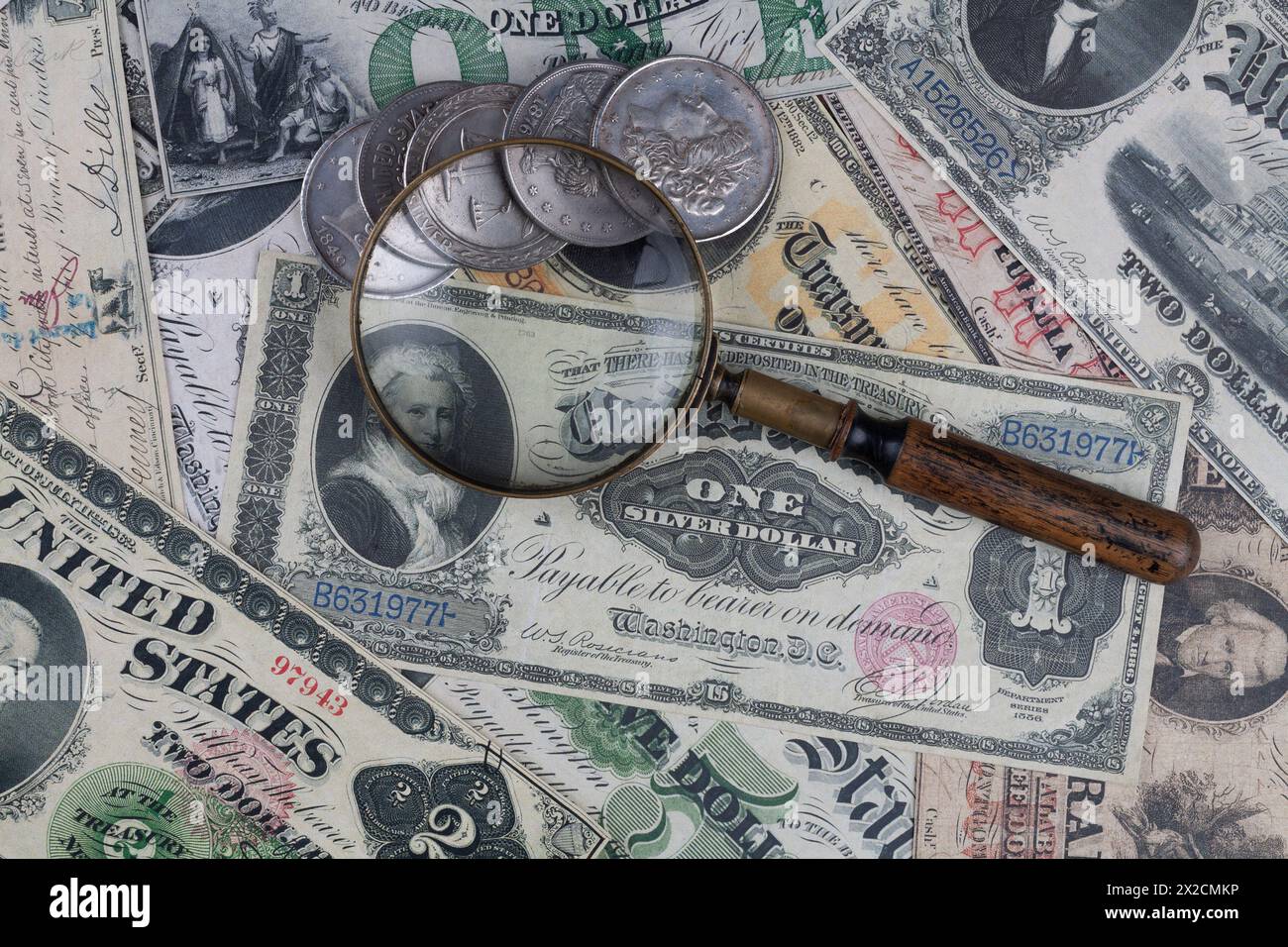 Old US banknotes and silver certificates with silver dollar coins and ...