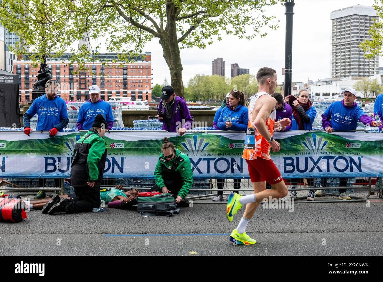 London, UK. 21st Apr, 2024. Milkesa Mengesha collapses at 39 km marker ...