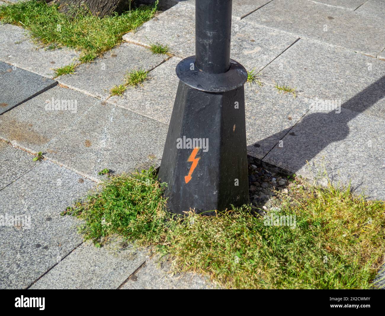 Lightning symbol on the base of a pole. Be careful of electricity. The ...