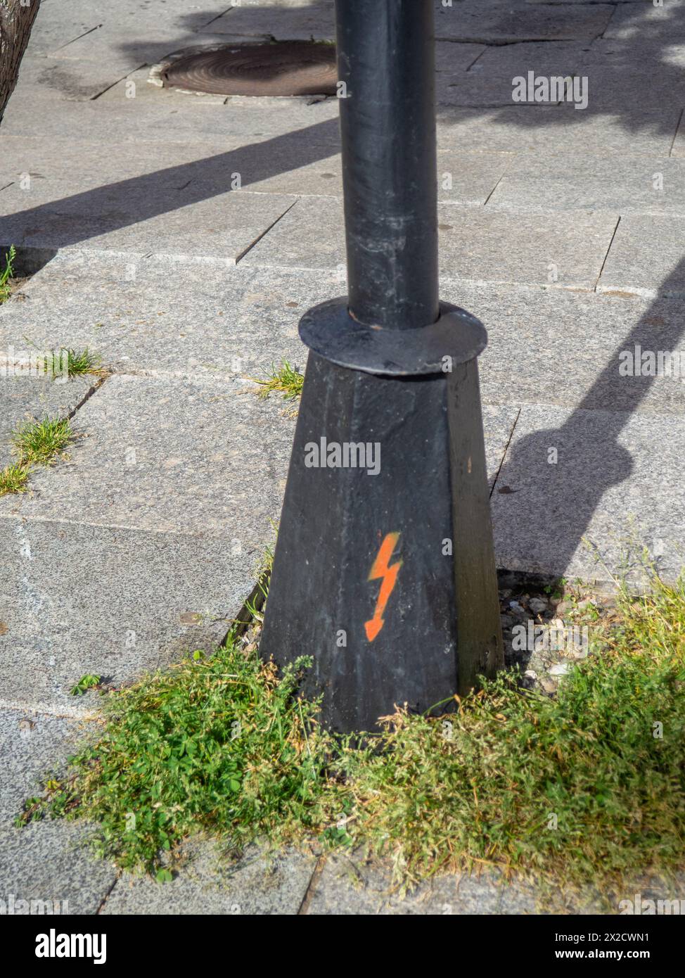 Lightning symbol on the base of a pole. Be careful of electricity. The ...