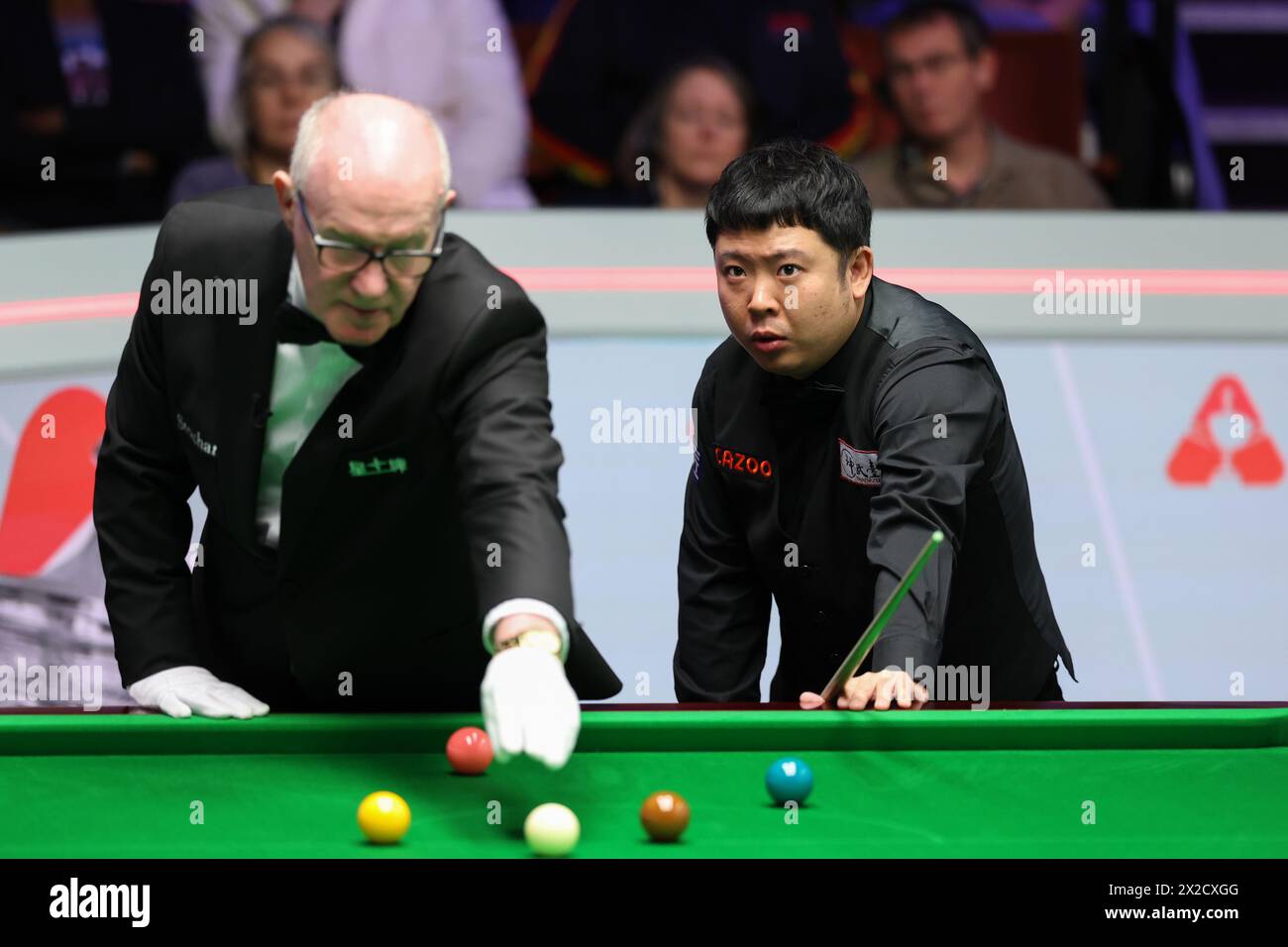 Sheffield, Britain. 21st Apr, 2024. Zhang Anda (R) of China reacts ...