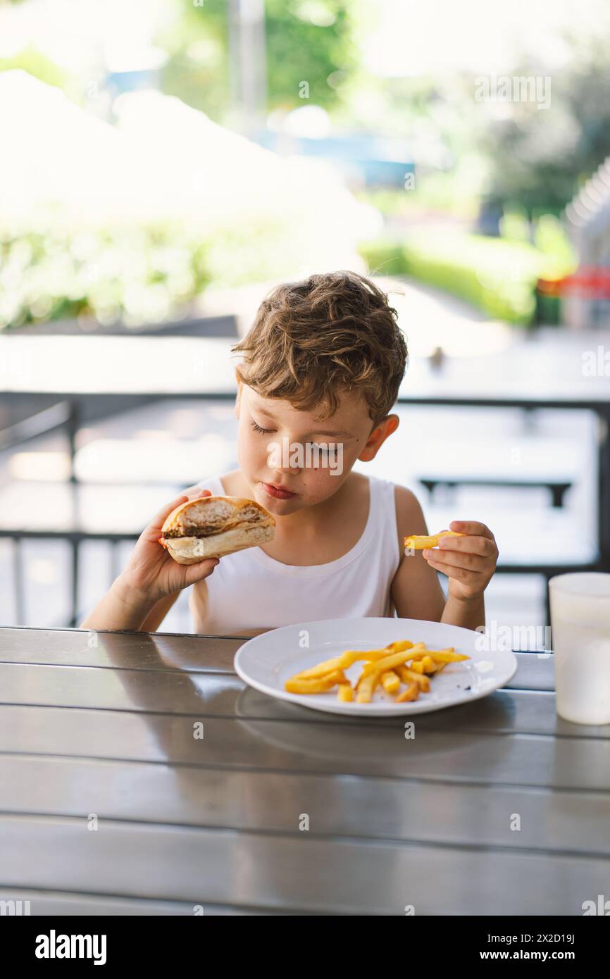 Boy eating sandwich cafeteria hi-res stock photography and images - Alamy