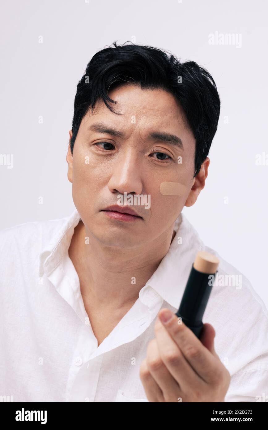 a middle aged man looking at a stick foundation Stock Photo - Alamy