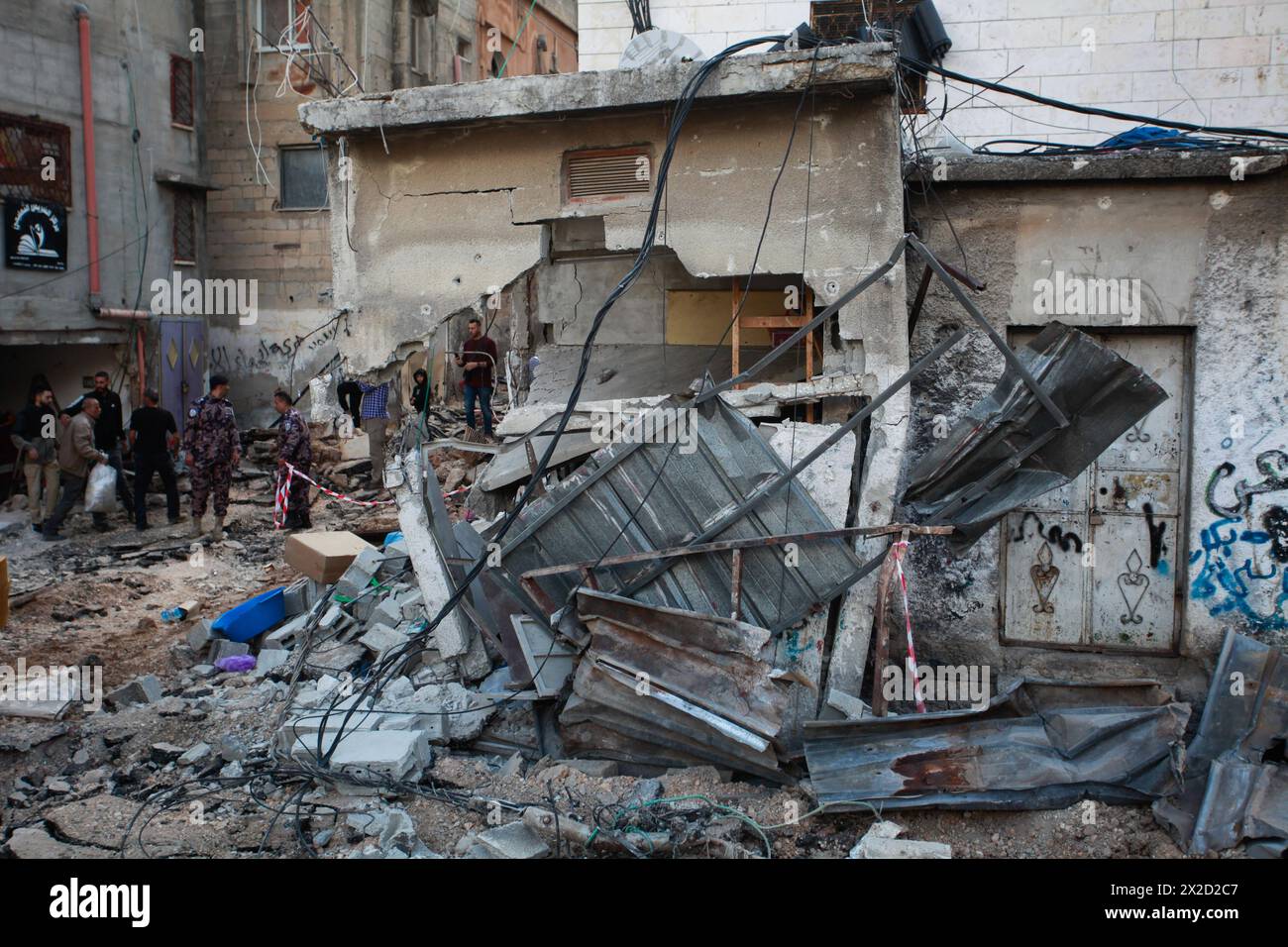 Palestinians inspect torched building in the West Bank refugee camp of ...