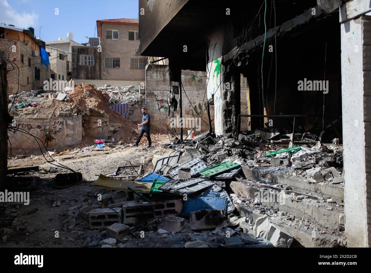 Palestinians inspect torched building in the West Bank refugee camp of ...
