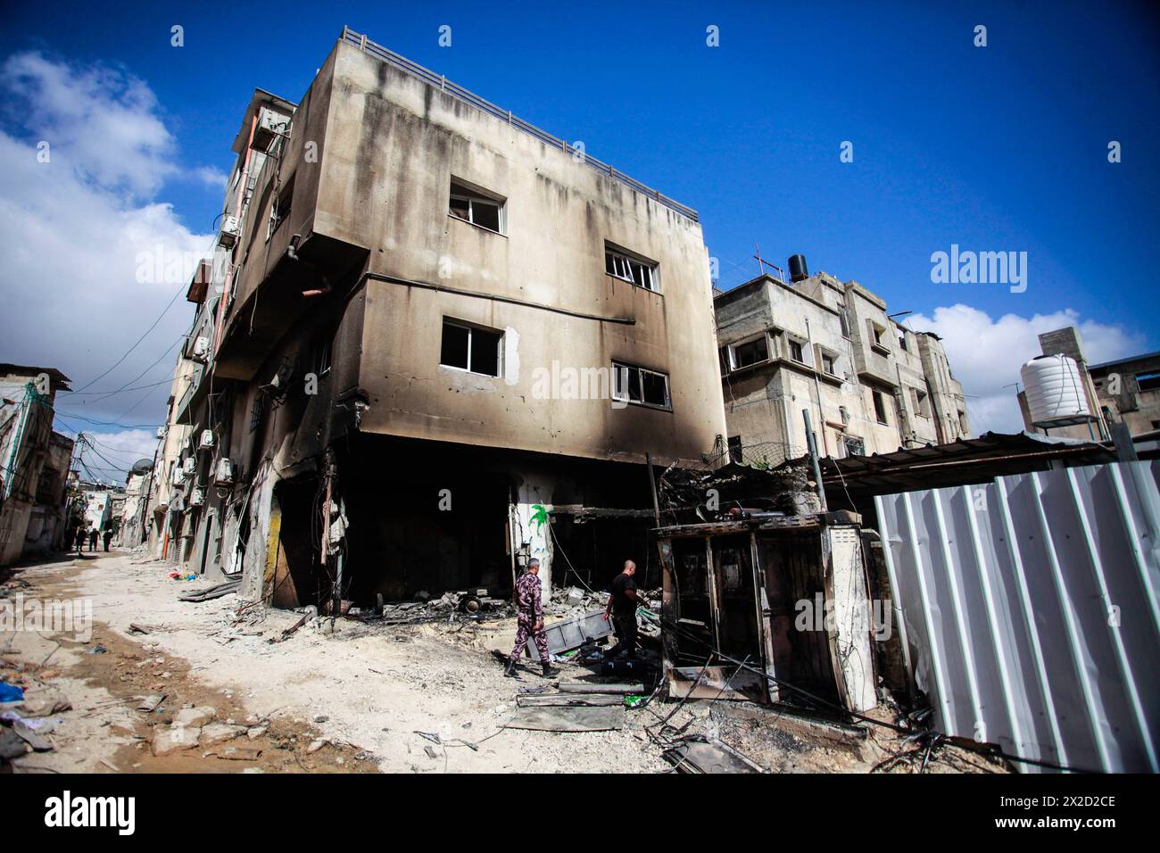 Palestinians inspect torched building in the West Bank refugee camp of ...