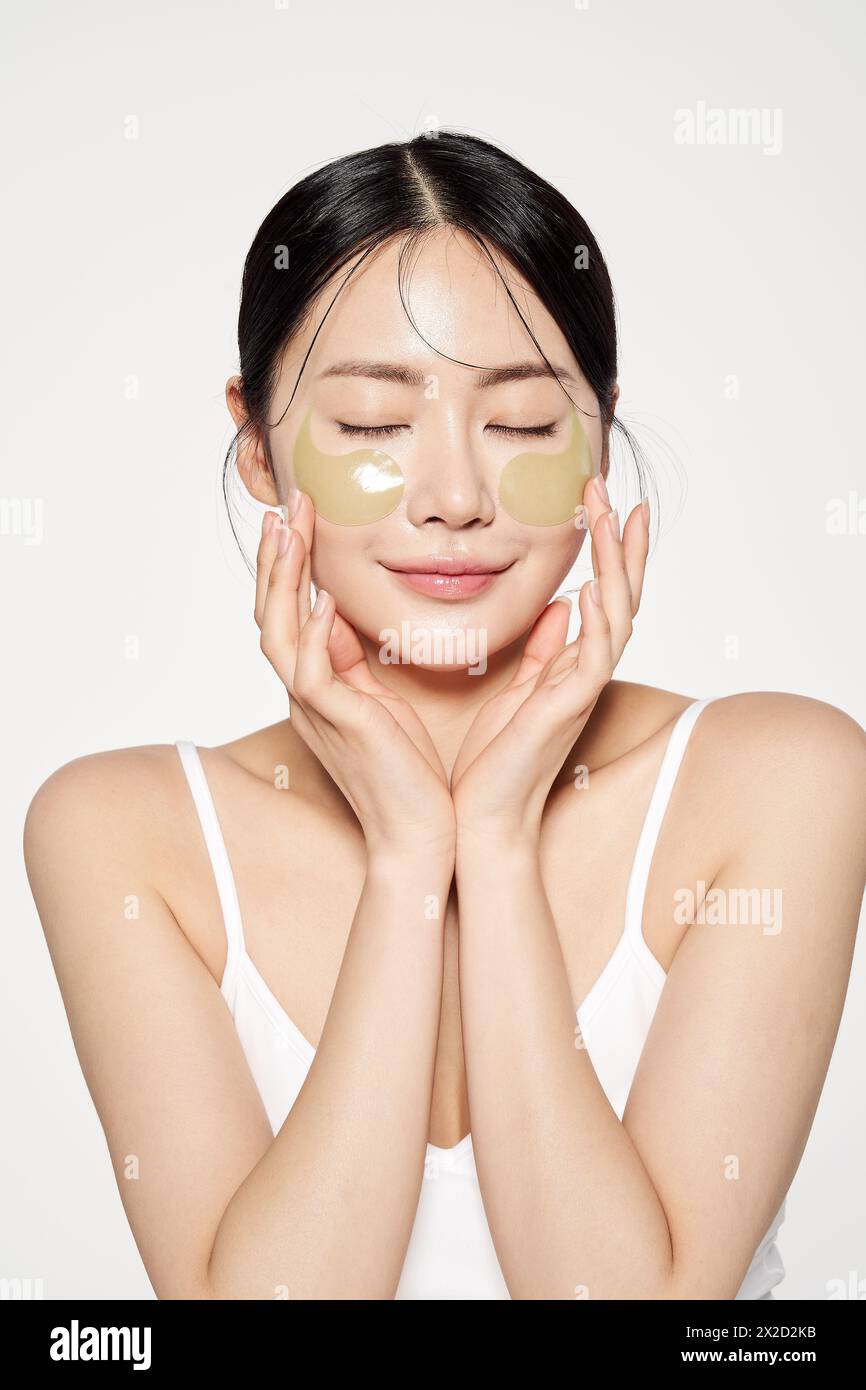 Asian woman with eye patches on both cheeks and gently closed her eyes ...