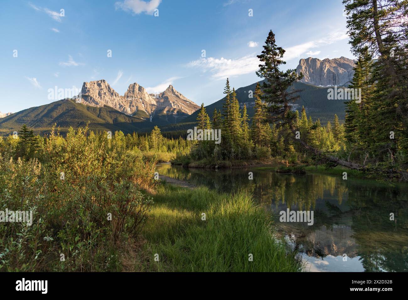 Incredible view of Three Sisters in Canada, Banff National Park with mountains reflecting in ...