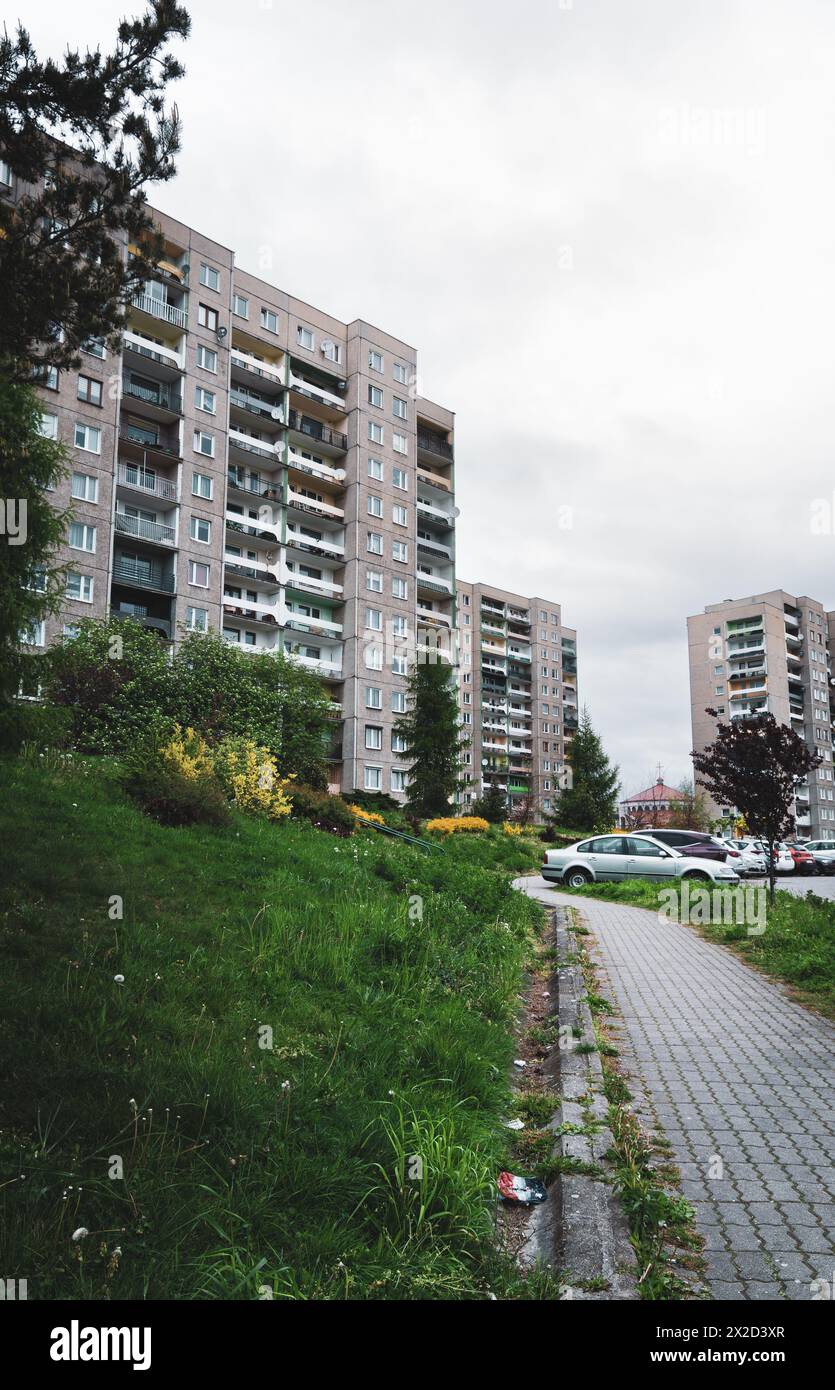 A grassy area with a neat row of apartment buildings in the background ...