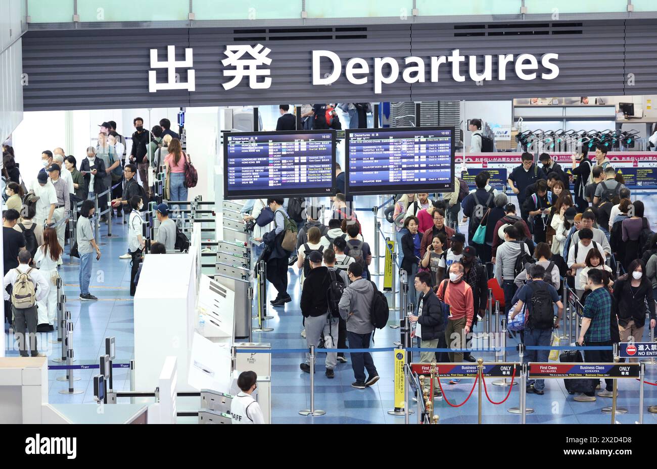 Departure lobby at Haneda International Airport is crowded with people ...