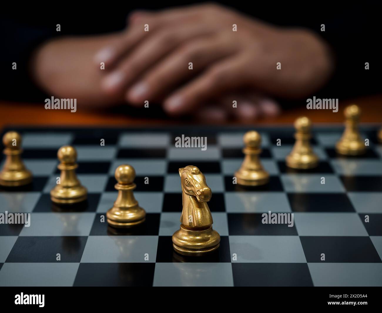 Gold horse, knight chess piece and gold pawn chess pieces on chessboard ...