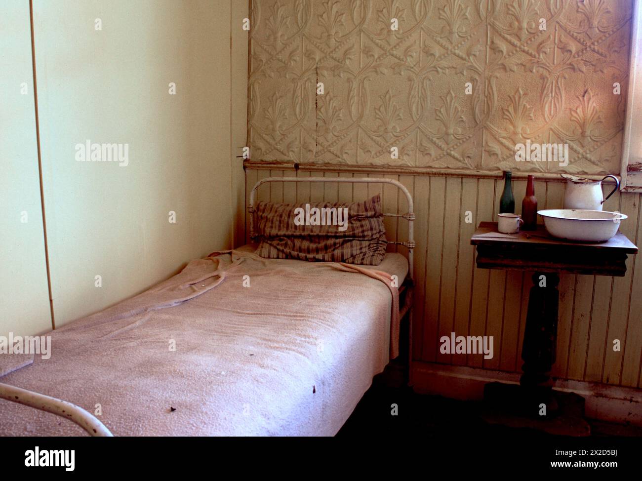 Old bed and nightstand, left undisturbed since 1940s, in a hotel room ...