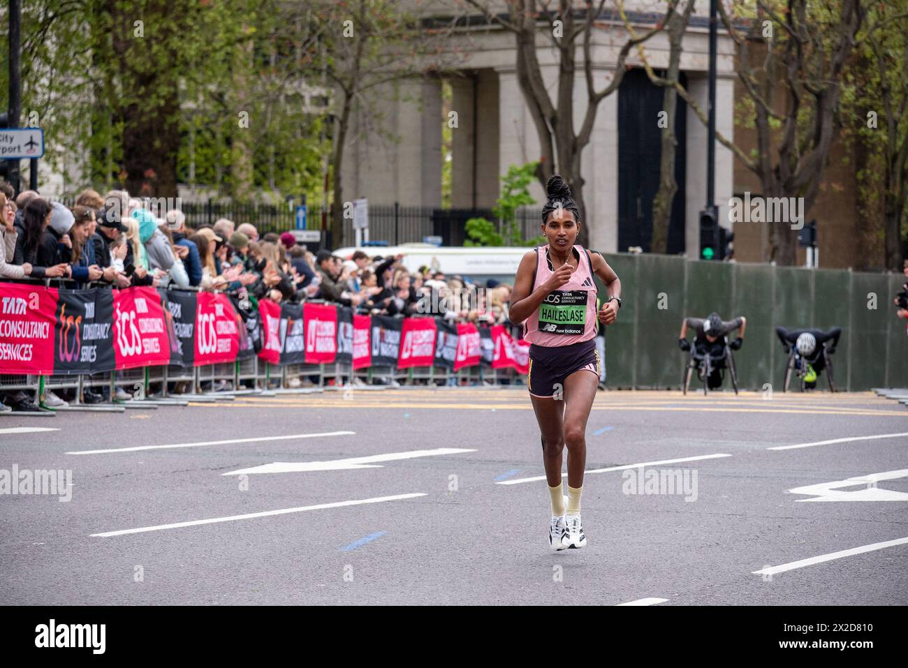 London, UK. 21st Apr, 2024. A female elite runner passing by while the ...