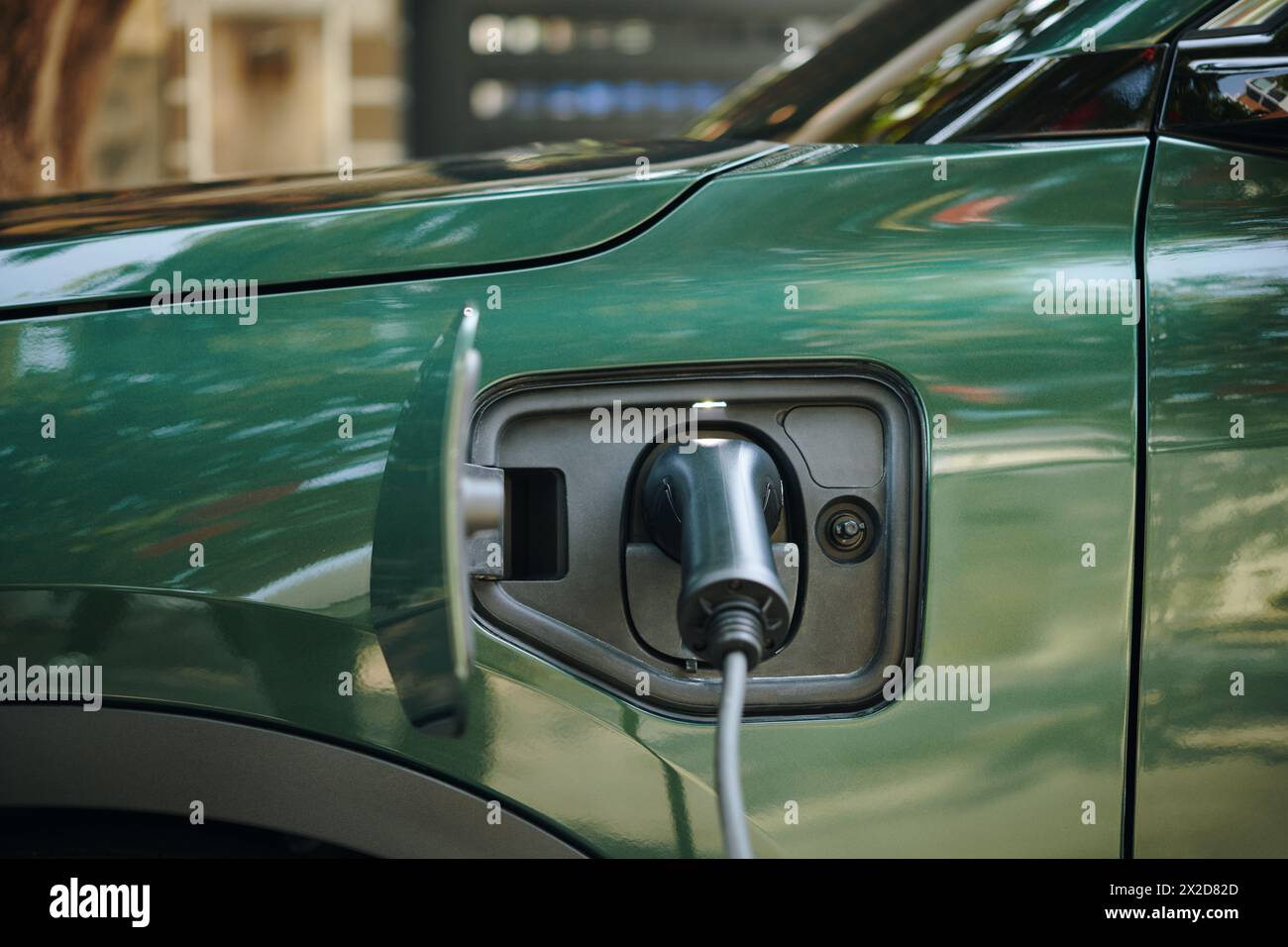 Plug inserted in electric car charge port Stock Photo - Alamy