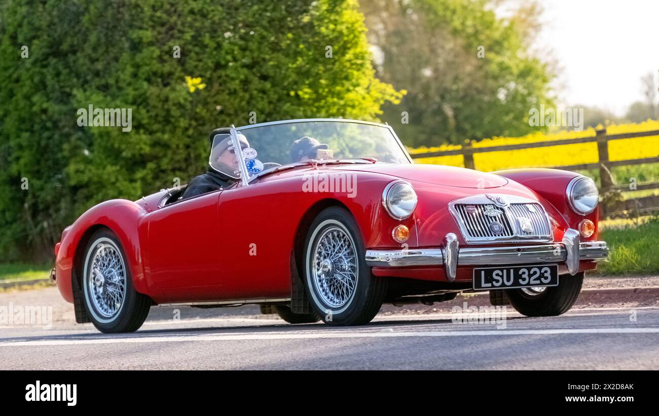 Bicester,UK- Apr 21st2024: 1959 red MGA classic car driving on a ...