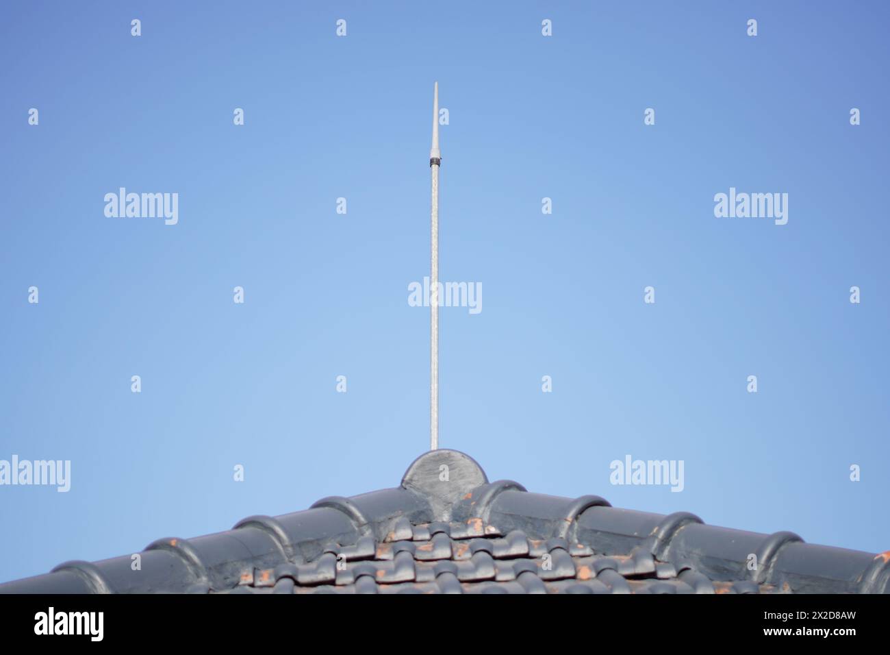 A lightning protection device installed on the roof tiles of a house ...