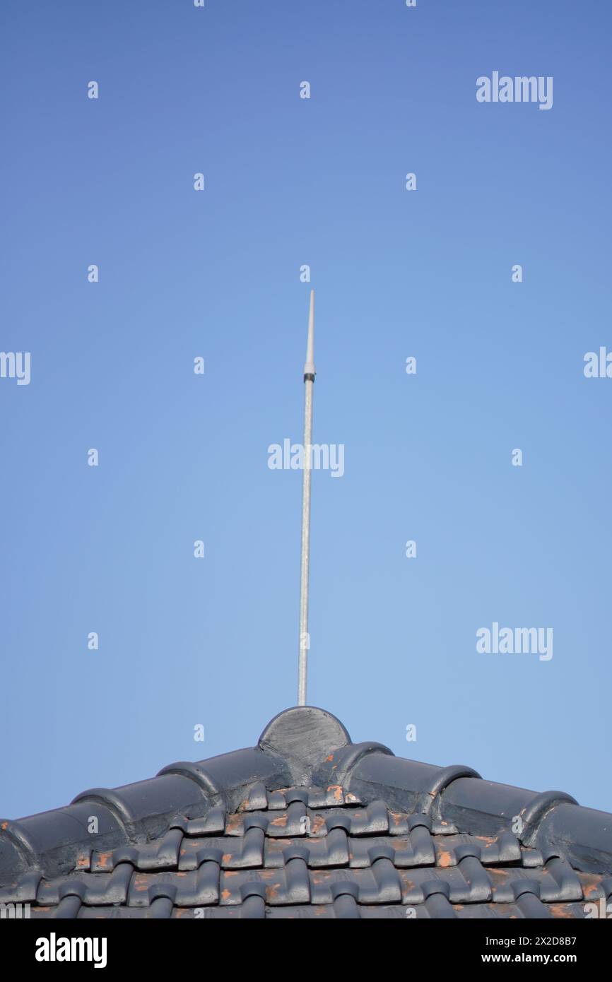 A lightning protection device installed on the roof tiles of a house ...