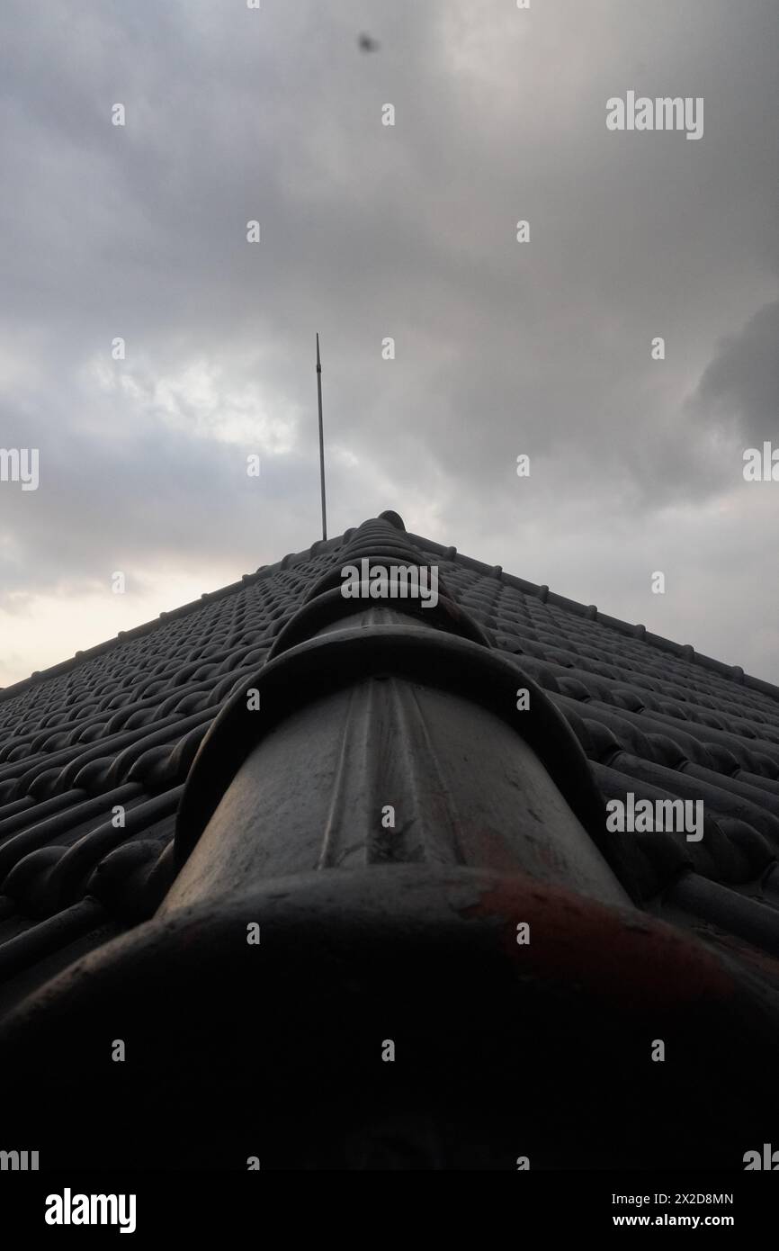 A lightning rod mounted on a roof with a cloudy sky background Stock ...