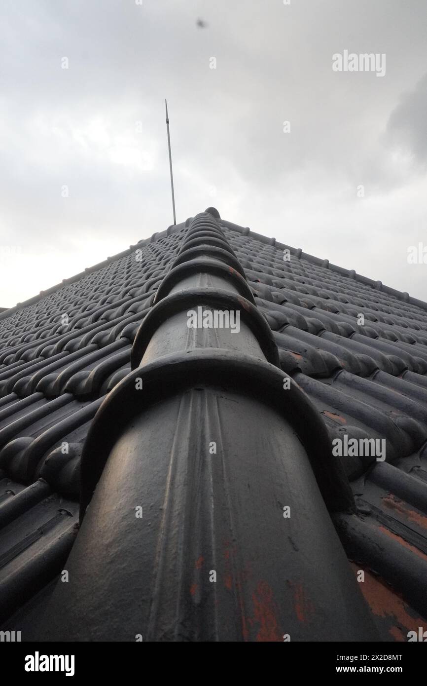 A lightning rod mounted on a roof with a cloudy sky background Stock ...