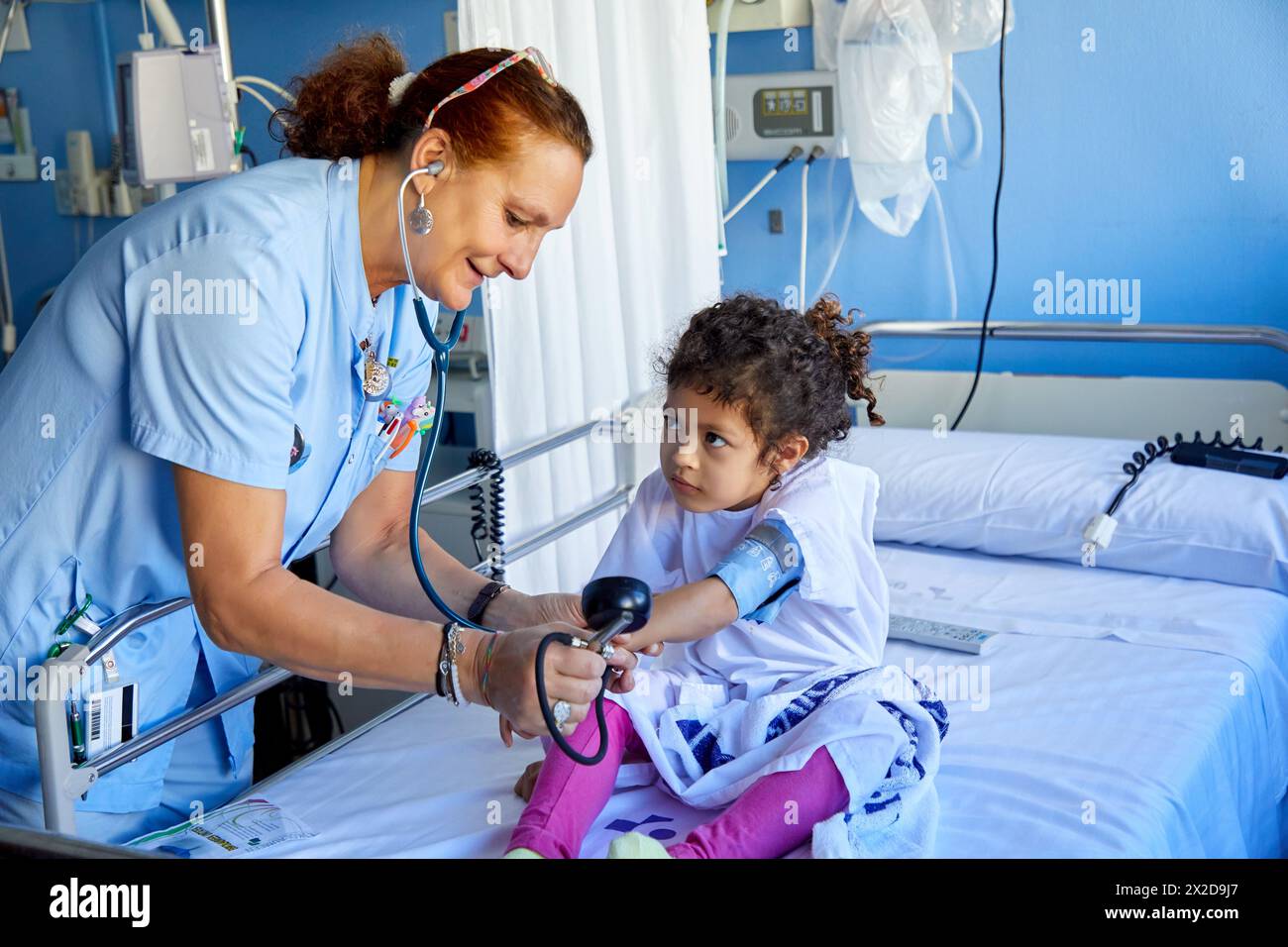 Nurse taking blood pressure to girl, Plant for hospitalization of ...