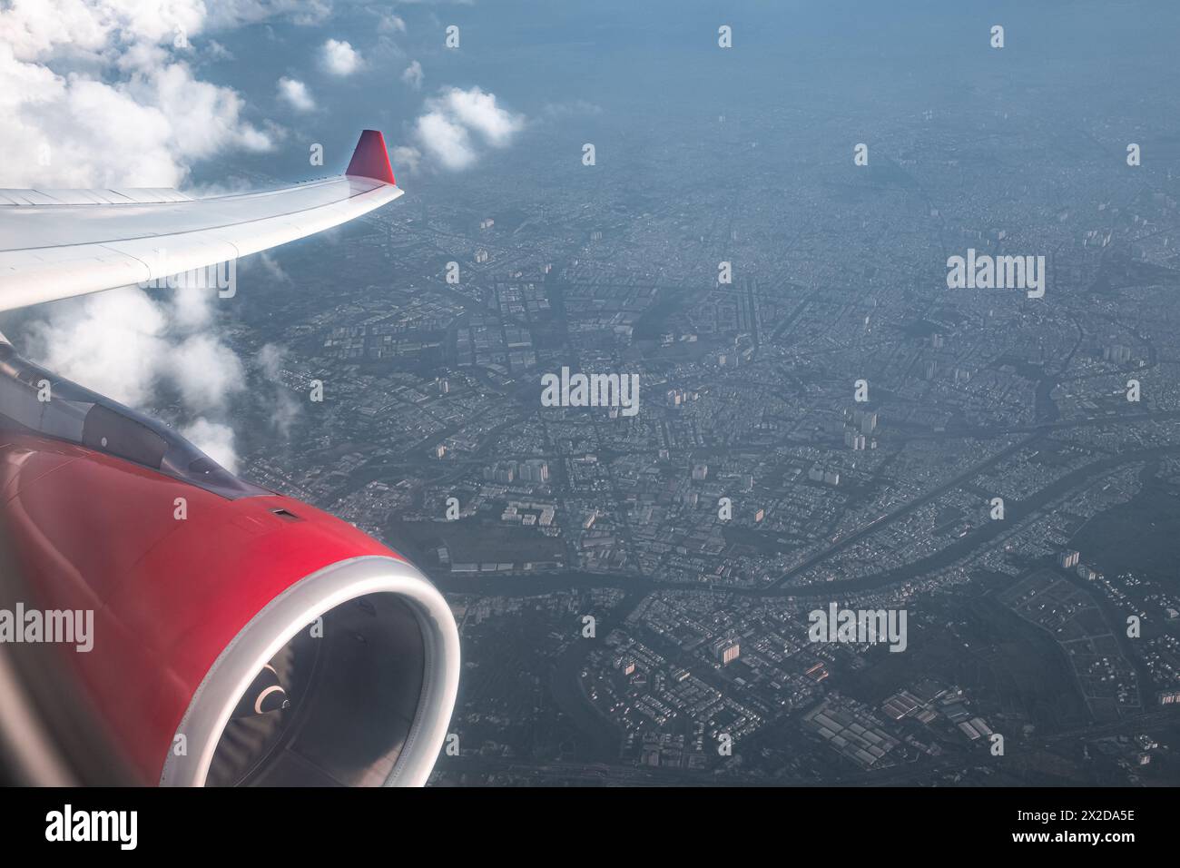 Cityscape View from Airplane Window. The wings of the plane through ...