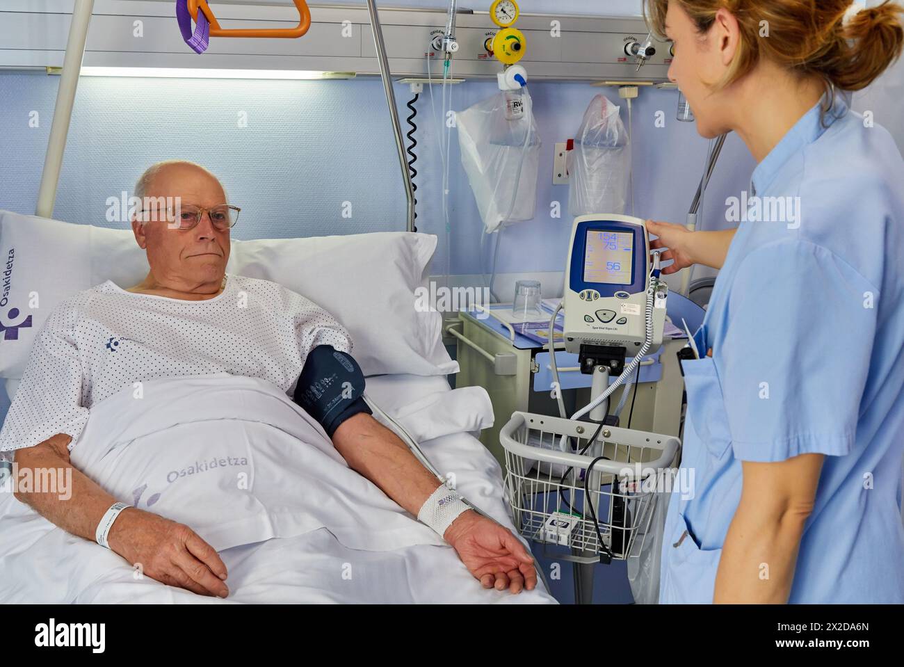 Nurse taking a patient's blood pressure, hospital room, Hospital ...