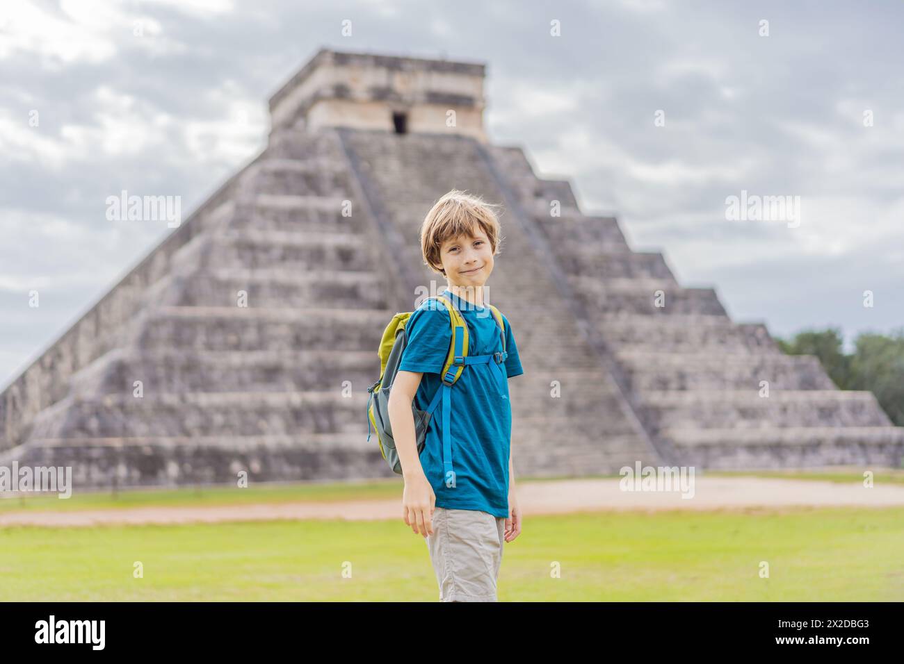 Boy traveler, tourists observing the old pyramid and temple of the ...