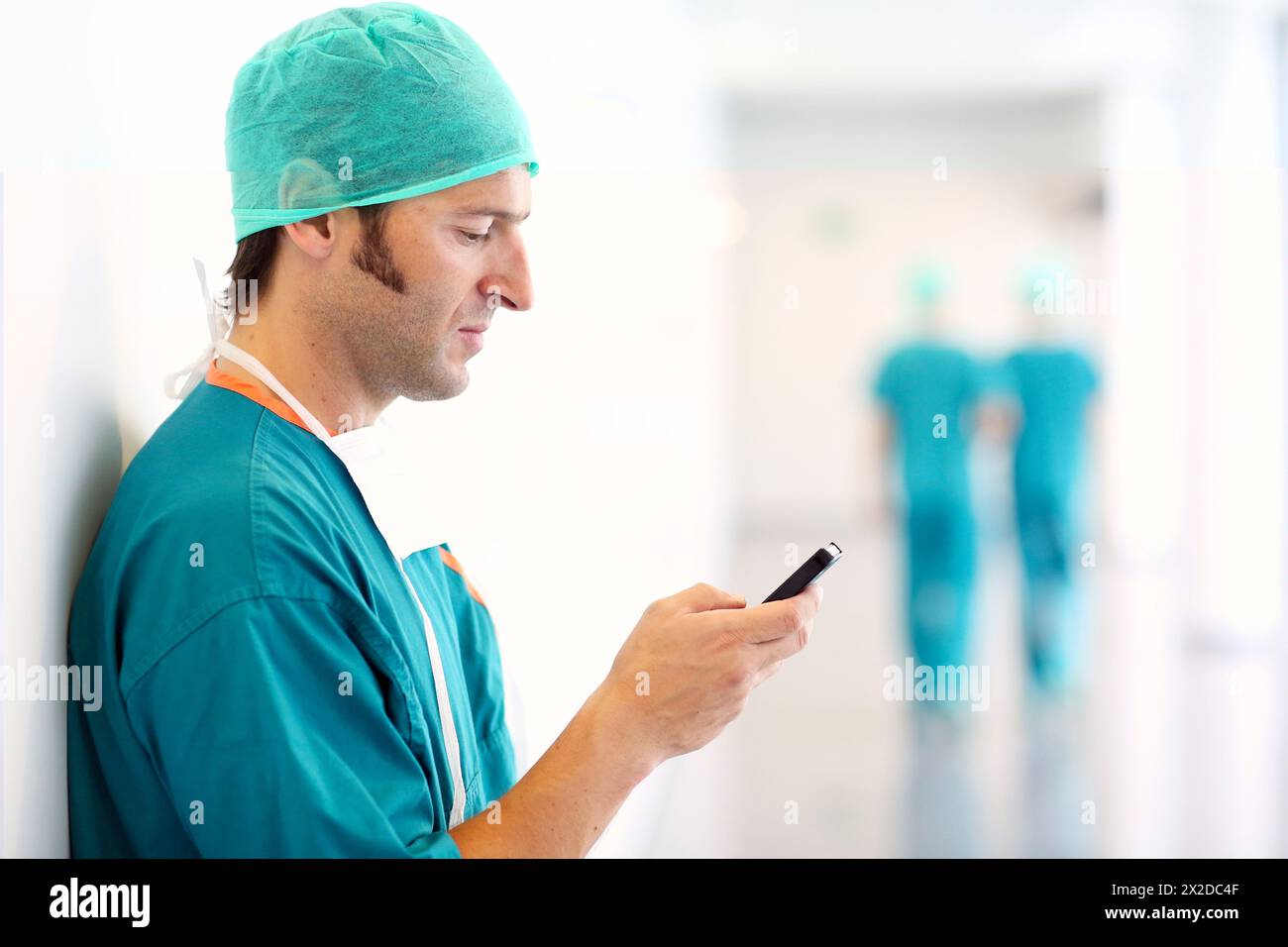 surgeon with smartphone in the operating room hallway, Onkologikoa ...
