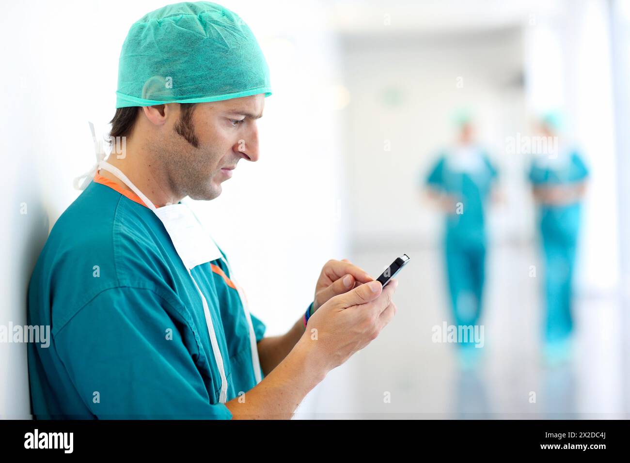 surgeon with smartphone in the operating room hallway, Onkologikoa ...