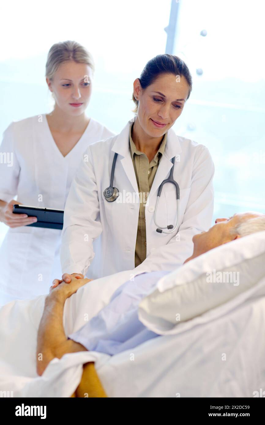 doctor attending to patient in hospital room, Onkologikoa Hospital ...