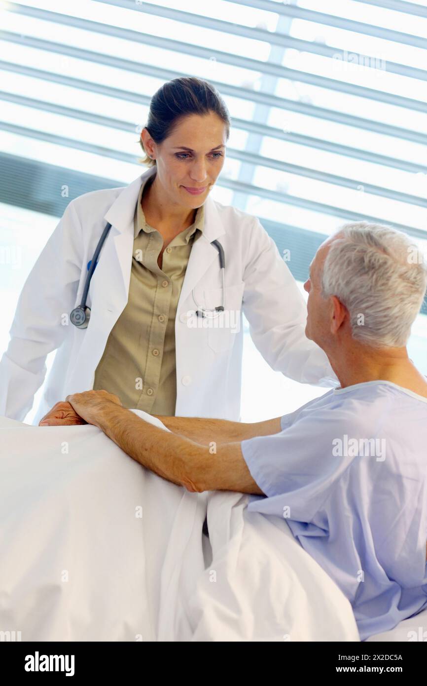doctor attending to patient in hospital room, Onkologikoa Hospital ...