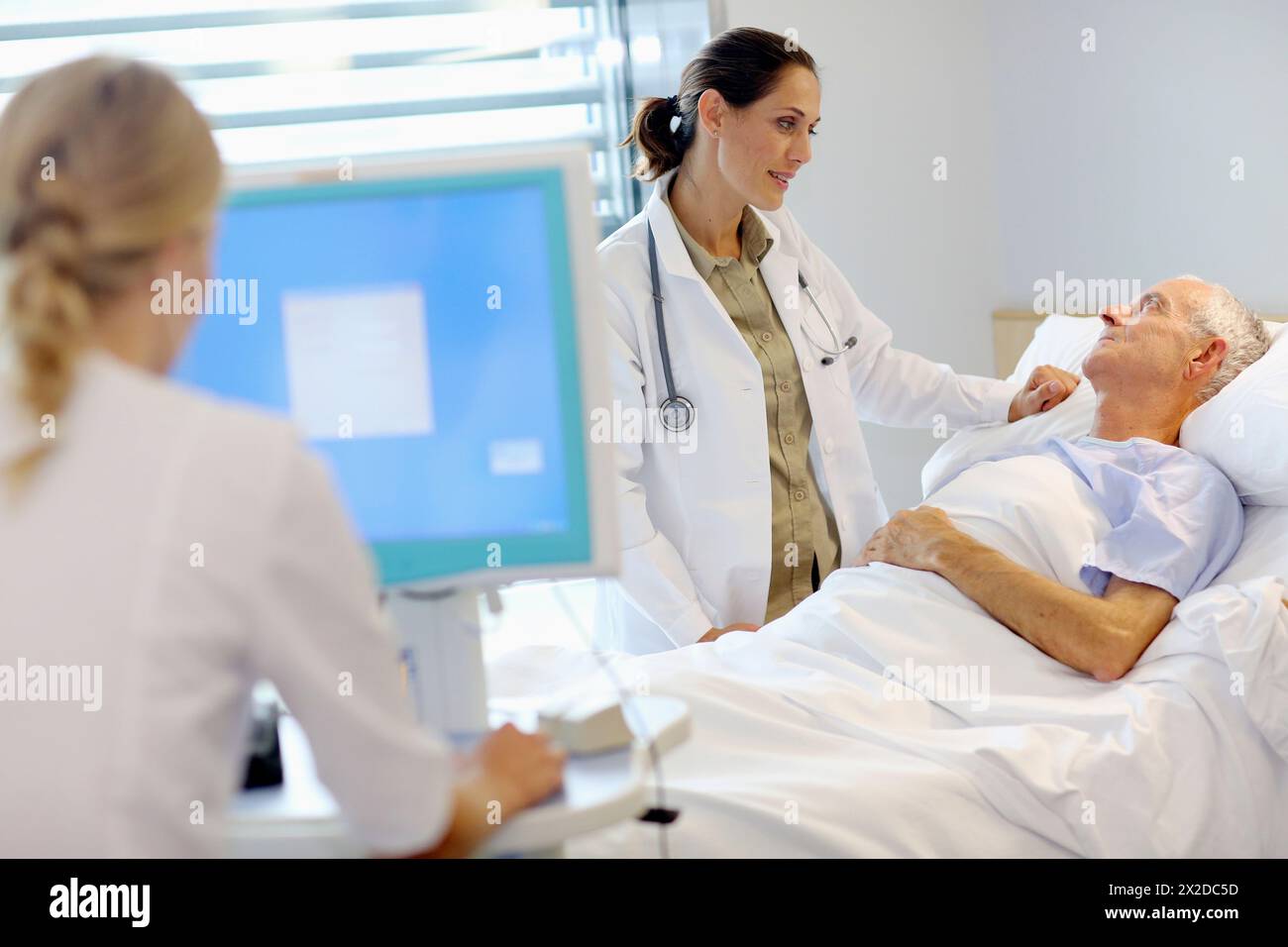 doctor attending to patient in hospital room, Onkologikoa Hospital ...