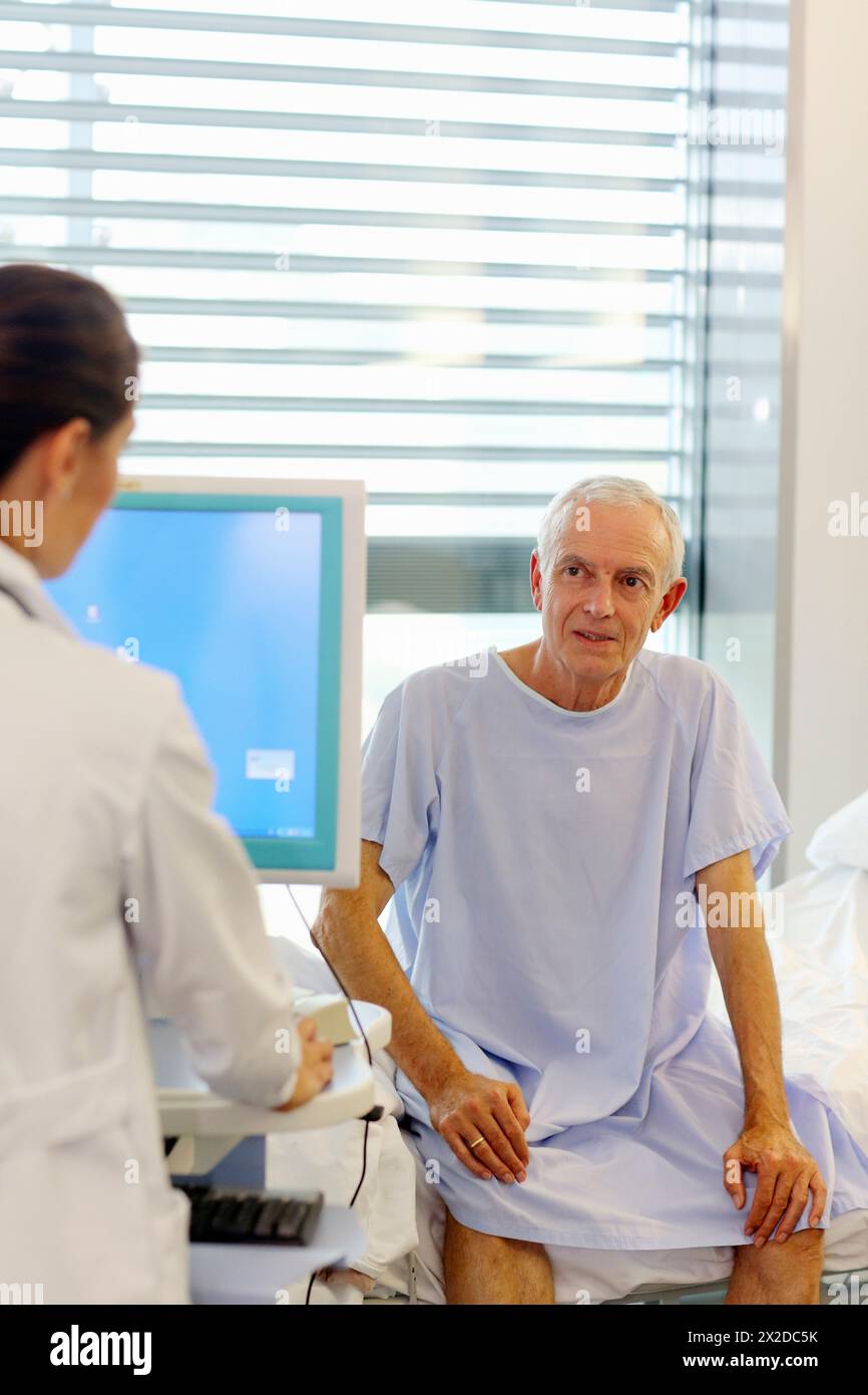 doctor attending to patient in hospital room, Onkologikoa Hospital ...