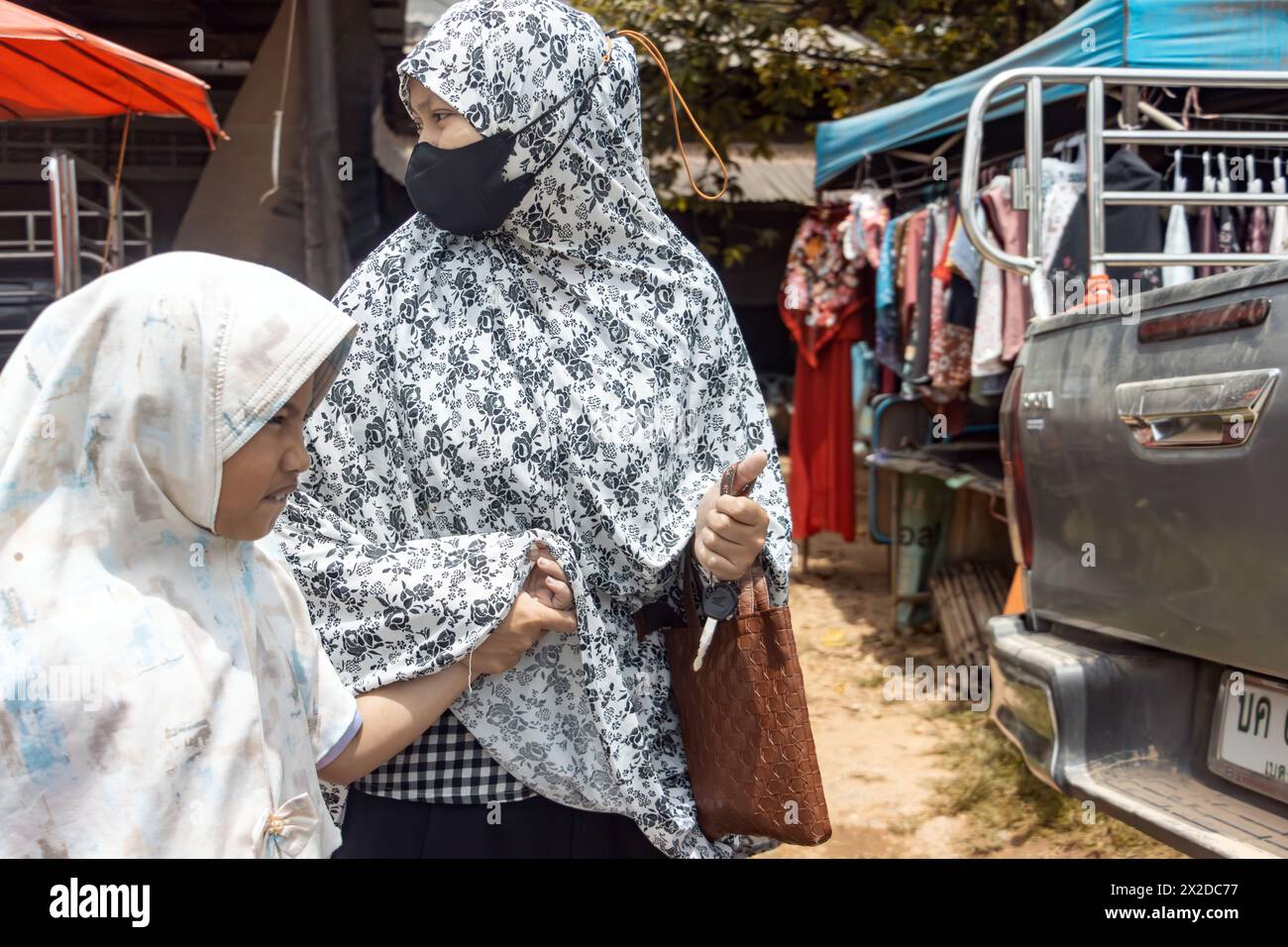 YALA, THAILAND, MAR 02 2024, A girl with a young woman in traditional ...