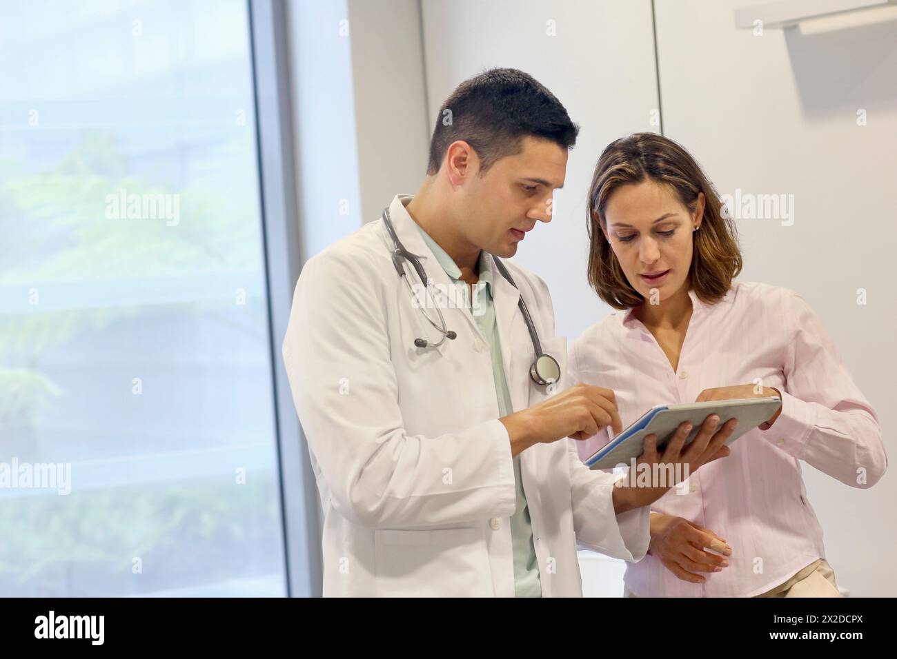 Doctor with patient in waiting room, Onkologikoa Hospital, Oncology ...