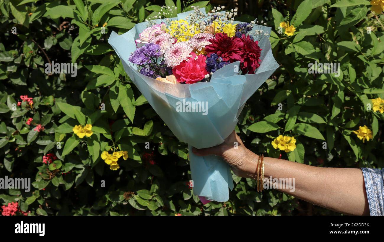 Hands holding a beautiful bouquet of flowers. Female holding flower ...