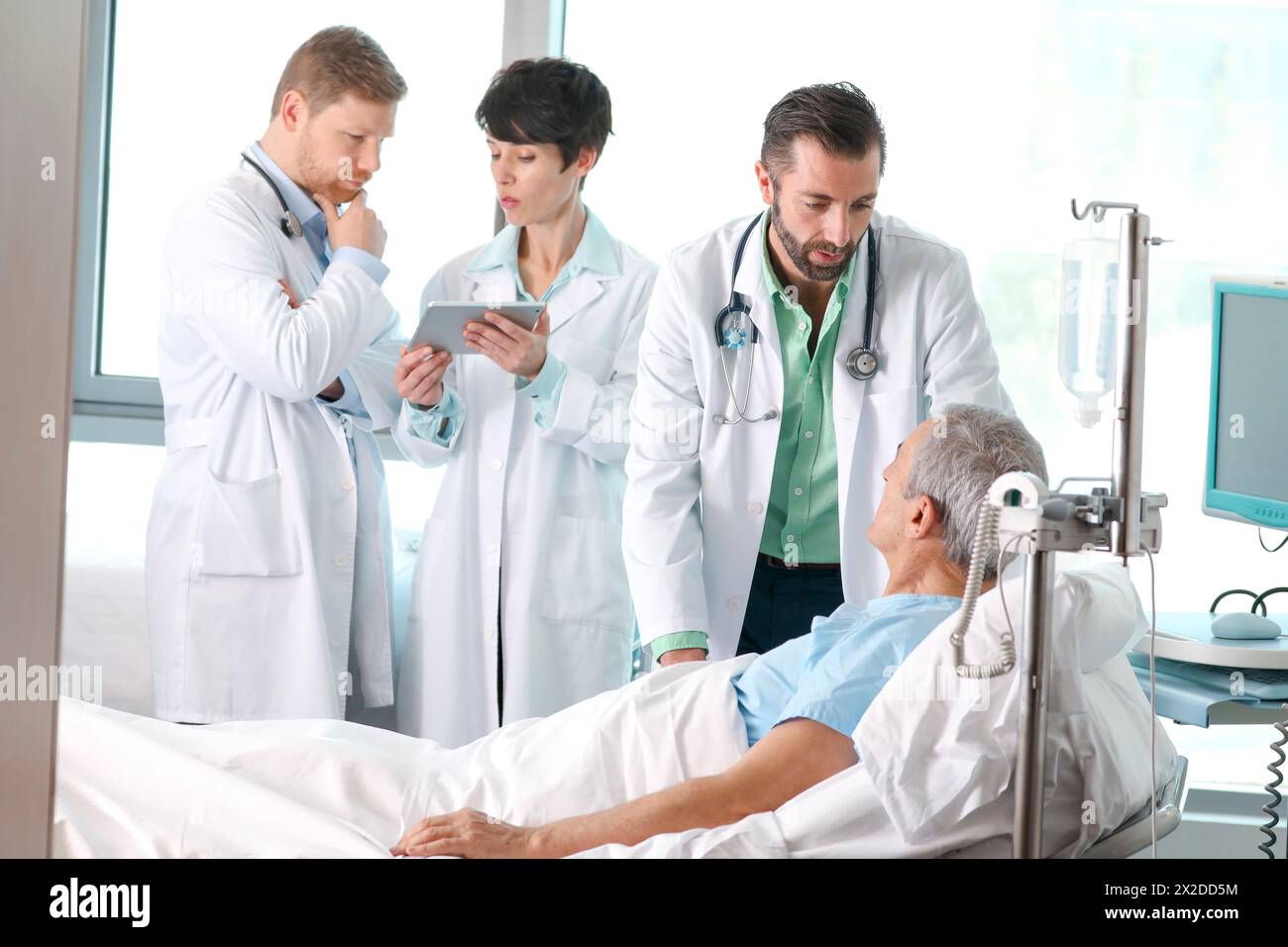 Patient in hospital room attended by a doctor, Hospital Stock Photo - Alamy