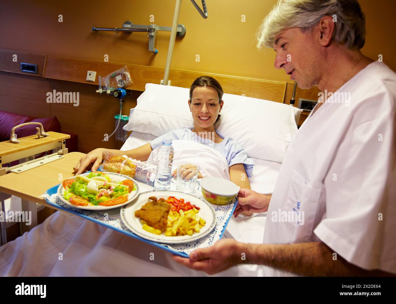 Nurse with food tray and patient in a hospital room. Hospital ...