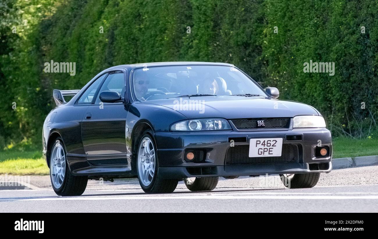 Bicester,UK- Apr 21st2024: 1997 Nissan Skyline classic car driving on a ...