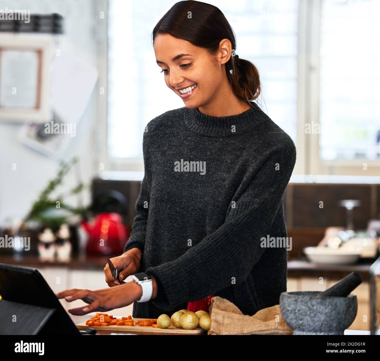 Woman, smile and cooking in kitchen with tablet for online recipe, explanation video and ...