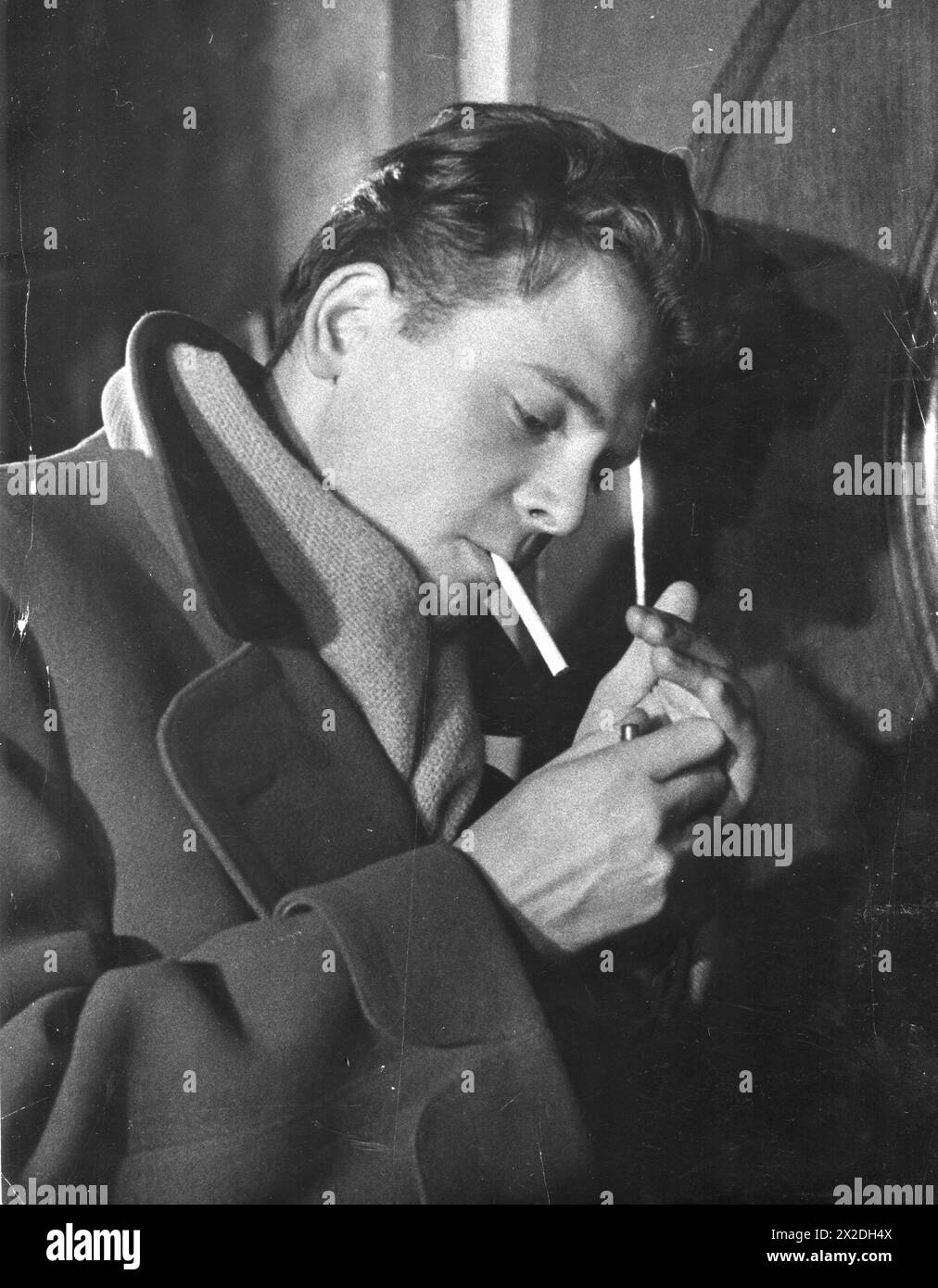 Scholz, Hans, German director, sparks a cigarette, circa 1955 ...
