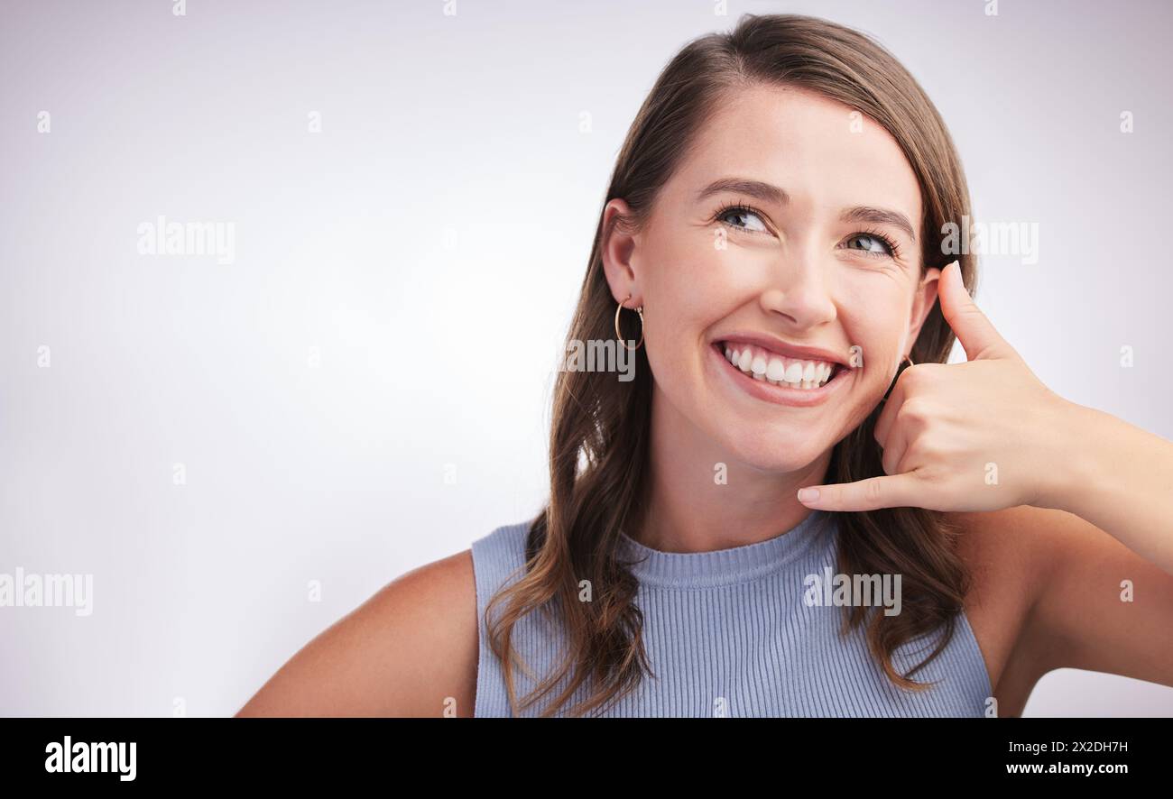 Woman, face and studio with hand gesture for phone call, contact us and ...