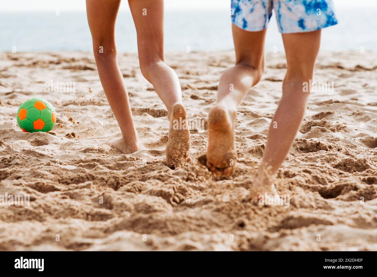 Kids playing football on the beach hi-res stock photography and images ...