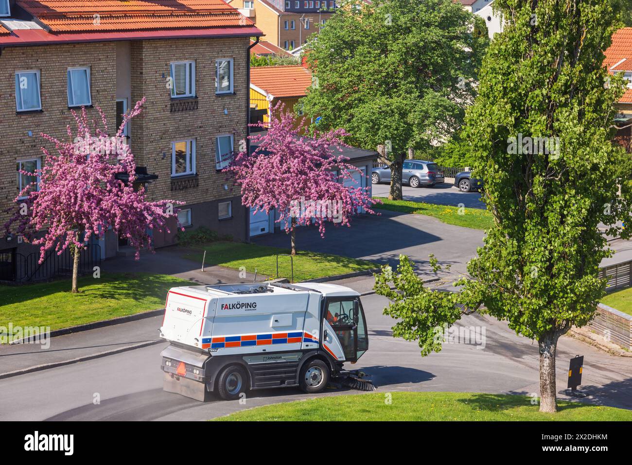 Street sweeper cleaning the street in a city Stock Photo - Alamy