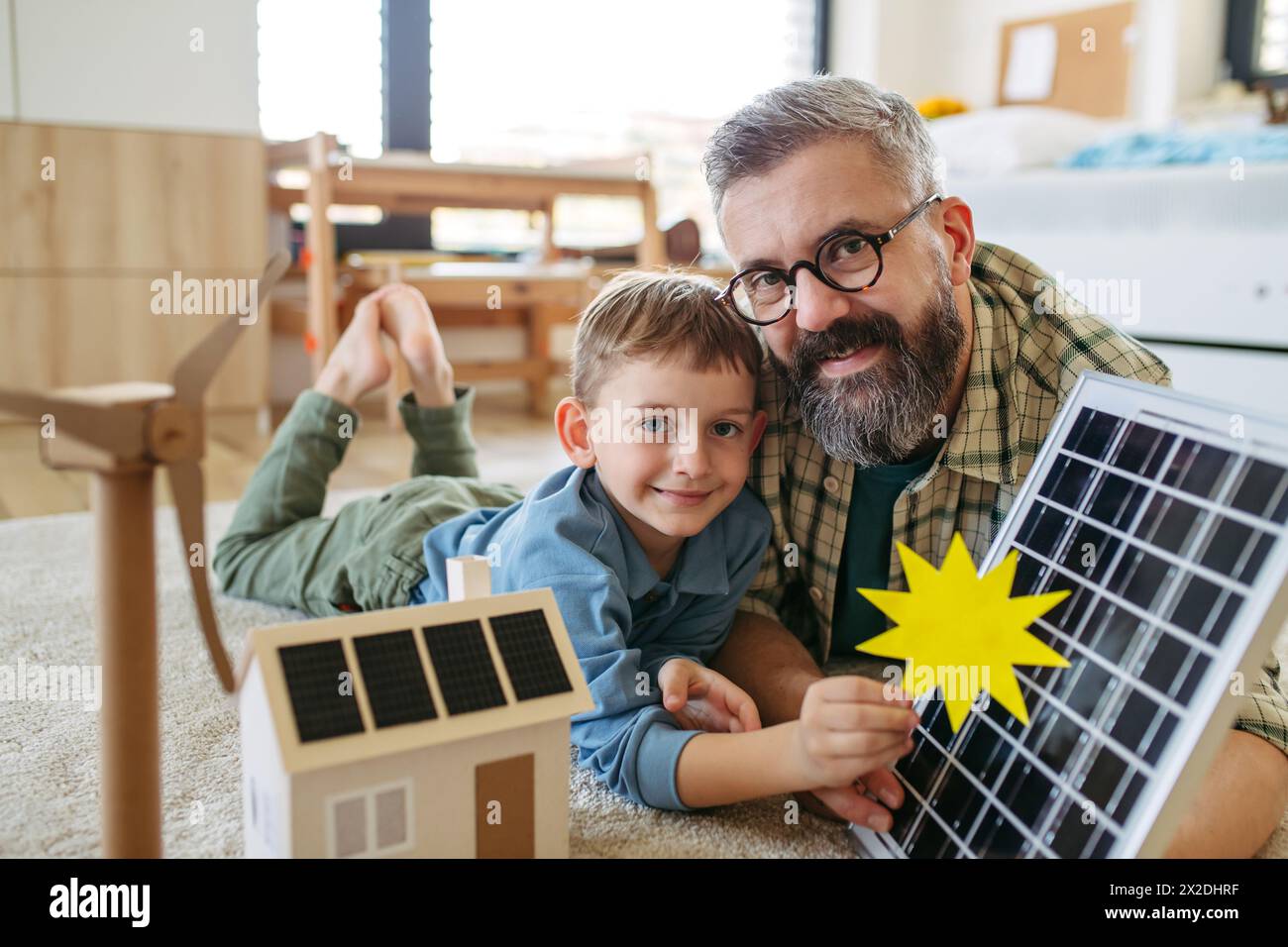 Father explaining renewable energy, solar power and teaching about ...