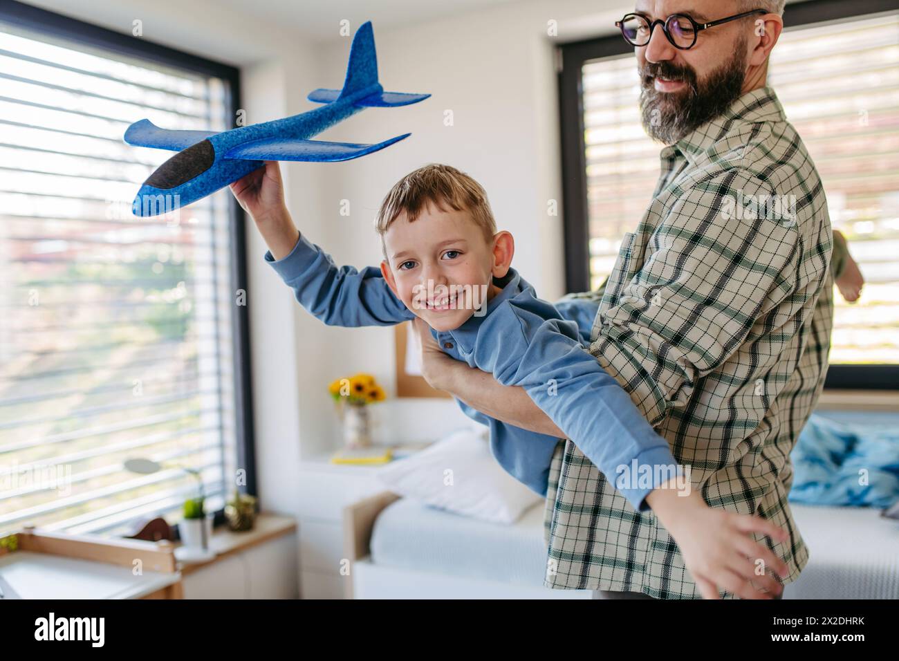 Playing with lightweight styrofoam planes. Playful father and son ...